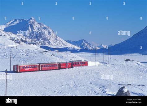 Raethische Bahn Train At The Bernina Pass In Winter Grisons Switzerland