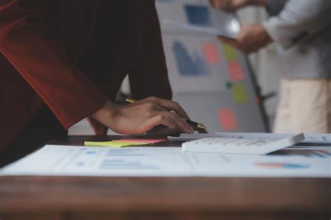 Premium Photo Close Up Of Business Team Analyzing Income Charts And Graphs With Modern Laptop