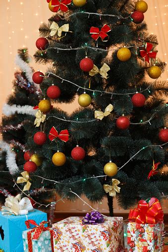 크리스마스 축하 휴일 시즌 및 파티를 위한 나무 근처의 선물 상자 크리스마스 놀라움 추수 감사절 선물 발표 및 휴일 트리 아래 바닥에 포장지에 크리스마스 선물이 있습니다 0