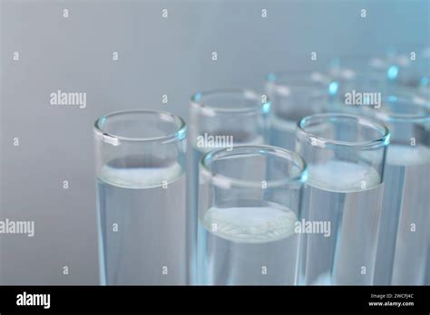 Laboratory Analysis Test Tubes With Liquid Samples On Color Background
