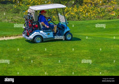 golf cart or golf club cars in a beautiful golf course with men driving