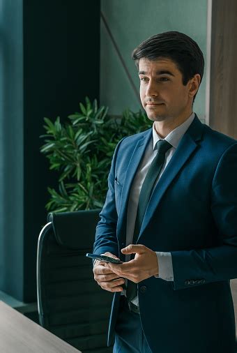 손에 휴대 전화를 가진 정장을 입은 사업가 소셜 넷을 사용하여 메시지를 입력하는 남자 뉴스 확인 비즈니스 미팅 만들기 현대적인 사무실 일반 관리자 Ceo 파트너에게 전화하기