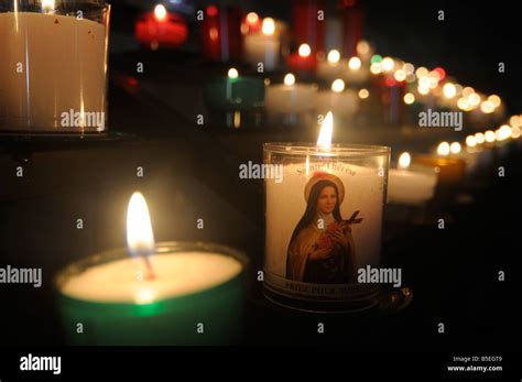 Candles With A Virgin Mary Icon Burning Inside A Church In Central