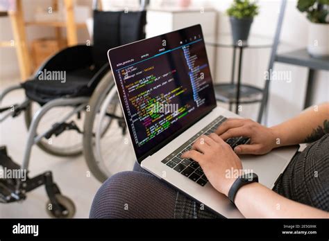 Hands Of Young Contemporary Disable Female Programmer Touching Keys Of Laptop Keypad While Hands Of Young Contemporary Disable Female Programmer Touching Keys Of Laptop Keypad While