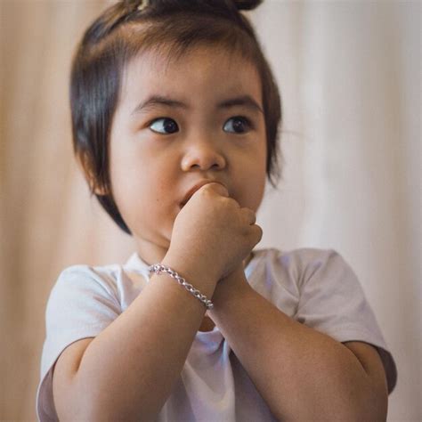 Premium Photo Close Up Of Cute Girl With Finger In Mouth At Home