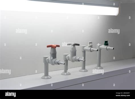 Four Different Colored Fluid Taps In A Laboratory Stock Photo Alamy