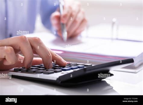 Businessman Using A Calculator To Calculate Invoice In Office Stock Photo Alamy
