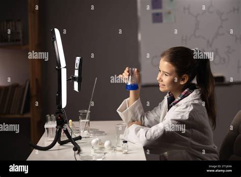 Smart Girl Showing A Flask With The Blue Chemical To The Camera While