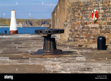 Windlass And Old Lighthouse At The Harbour In Cullen In Morayshire
