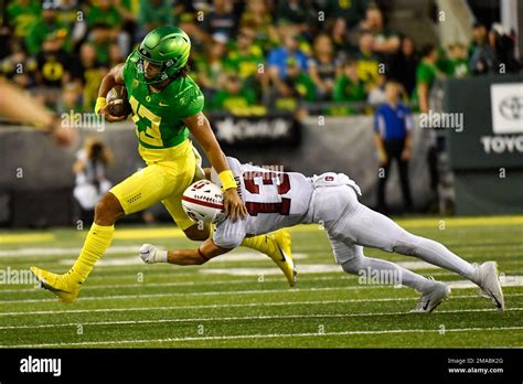 Oregon Quarterback Ty Thompson 13 Tries To Elude The Tackle Of