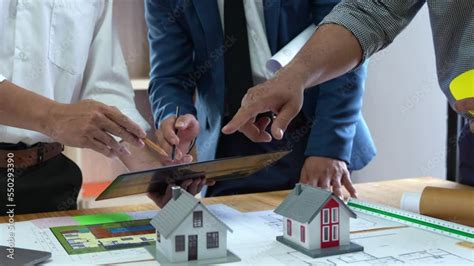 Businessman And Architect Meeting For Planing And Checking House Design