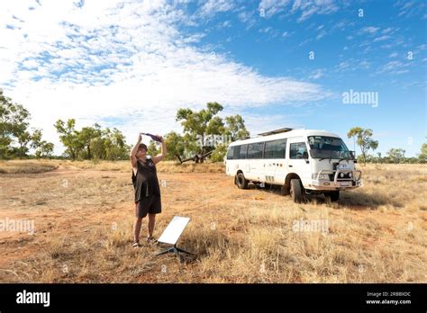 Person Setting Up Starlink Internet Satellite Connection While Camping In Remote Australian
