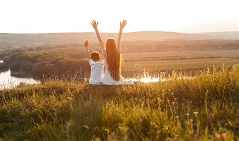 Anonymous Brother And Sister Enjoying Sunset In Countryside Stock Image