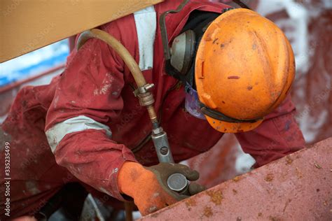 Process Of Derusting Paint And Rust Removal By Pneumatic Chisel From Ship Deck By Vessel Crew