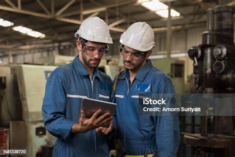 디지털 태블릿 컴퓨터로 작업하는 산업 공장의 남성 공장 노동자 유지 보수 기계 그룹 선반 기계를 검사하는 남성 기술자 작업장에서
