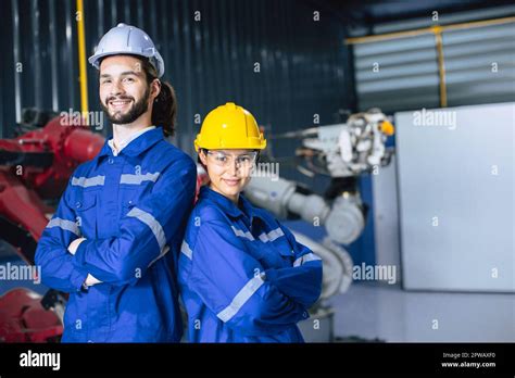 Two Technician Man And Woman Engineer Worker Standing Smile In Robot