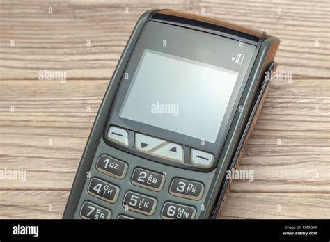 POS Terminal Payment Machine On Wooden Background Contactless Payment NFC Technology Stock