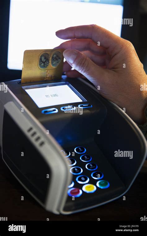 Hand Putting Bank Card Into Card Reader Stock Photo Alamy