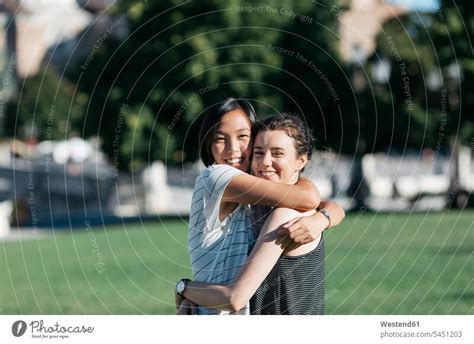 Portrait Of Two Best Friends Hugging Each Other In The Park A Royalty