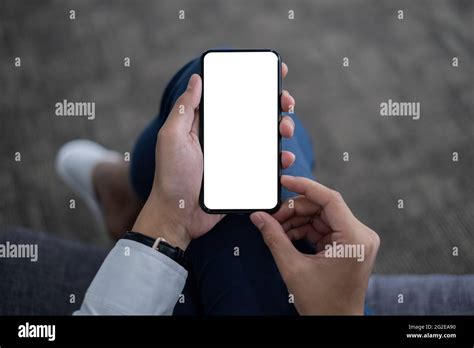 A Man Hand Holding Smartphone Device With Blank Screen Top View Stock Photo Alamy