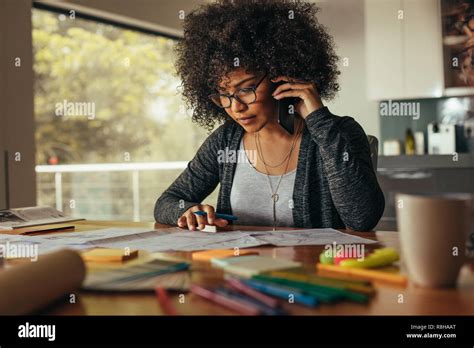 Female Architect Making A Project Plan And Talking Over Phone Female Interior Designer Reading