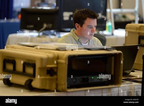 Michael Klug Of Integral Marketing Works On His Laptop Computer Positioned Between Ruggedized