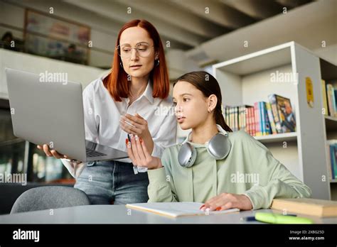 Redheaded Woman Tutors A Teenage Girl In A Library Both Engaged And