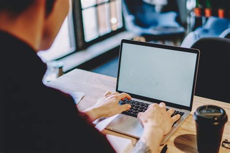 Young Man Searching Information For Course Work On Website On Netbook
