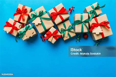 포장된 크리스마스 또는 다른 휴일 수제 선물은 색깔 리본을 가진 종이에 있는 선물 상자 다채로운 테이블에 선물의 장식 복사