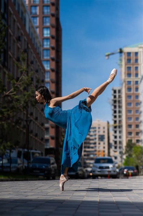 Beautiful Asian Ballerina In Blue Dress Posing In Splits Outdoors