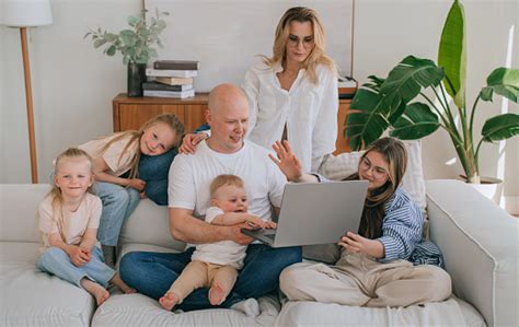 Keluarga Ceria Duduk Di Sofa Menggunakan Laptop Membuat Video Call