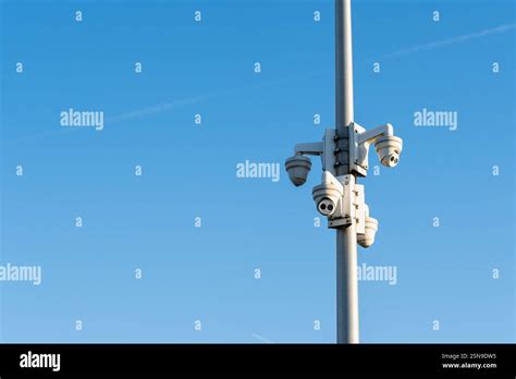 Multiple Surveillance Cameras In City Attached To A Tall Metal Pole For Urban Monitoring And