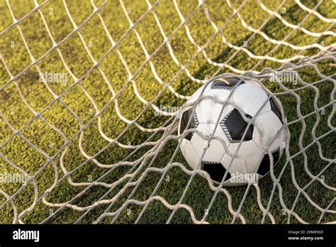 A black and white soccer ball propelled by a powerful shot, tearing ...