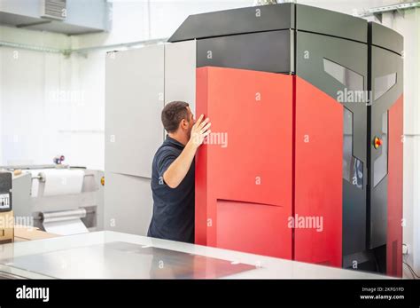 Professional Worker With Modern Big Offset Printing Machine In Print