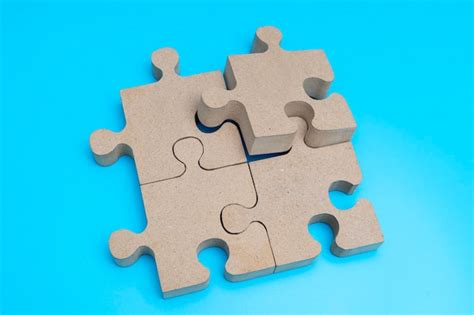 Premium Photo Wooden Jigsaw Puzzle Parts On Blue Background Four