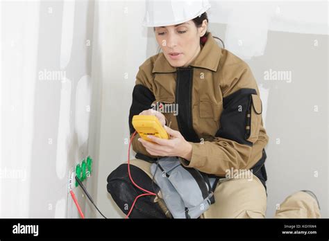 Female Electrician Installing Electrical Socket On Wall Stock Photo Alamy