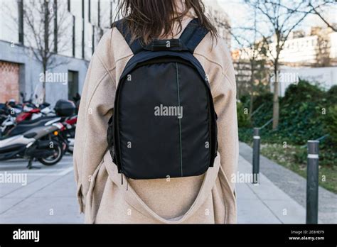 Back View Unrecognizable Female In Warm Coat Carrying Black Backpack