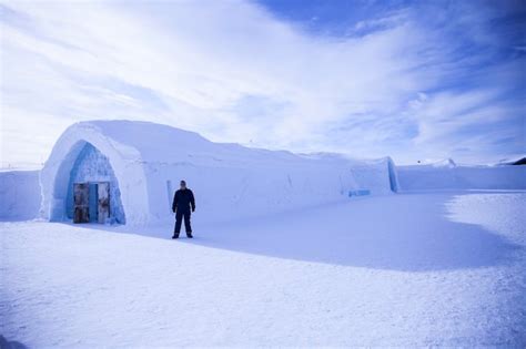 Premium Photo Man Standing In Front Of A Giant Ice Igloo