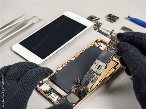 Technician Or Engineer Disassembling Components Broken Smartphone And