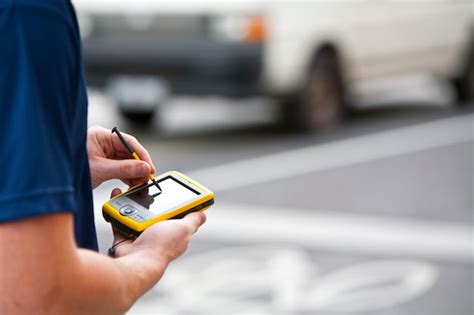 Premium Photo A Man Uses A Handheld Gps Unit To Navigate