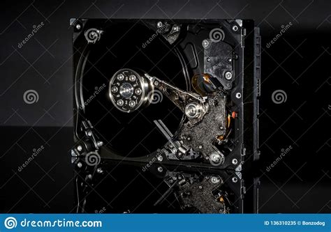 disassembled and opened hard disk drive inside view with reflections