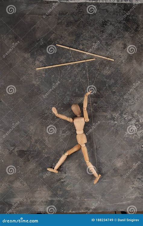 Puppet In The Hands Of Puppeteer Walks On Background The Concept Of Manipulation Copy Space