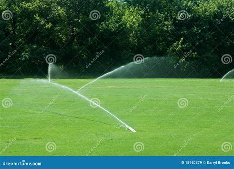 Sprinklers Irrigating A Green Grass Field Stock Image Image Of Drought Water 15957579
