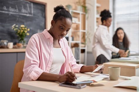 Premium Photo Concentrated Woman Making Notes In Study Room