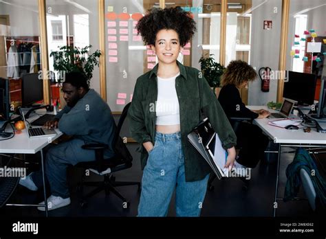 Portrait Of Confident Female Computer Programmer Standing With Hand In
