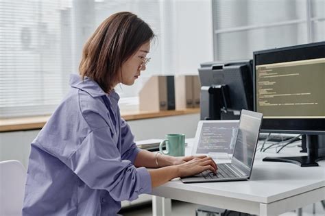 Premium Photo Young Woman Typing Codes On Laptop