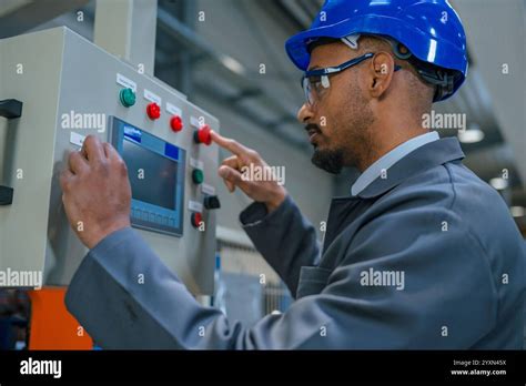 African American Professional A Factory Engineer Updating Industrial Control Panel Modern