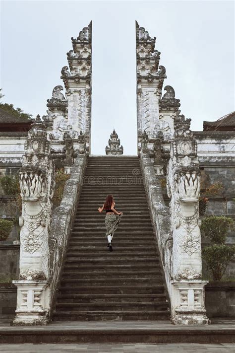 Young Woman Climbing Up Stone Stairs To Gates Of Heaven In Pura