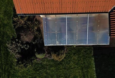 Terrace With Wooden Pergola And Plexiglass Roof Vines Are Straining