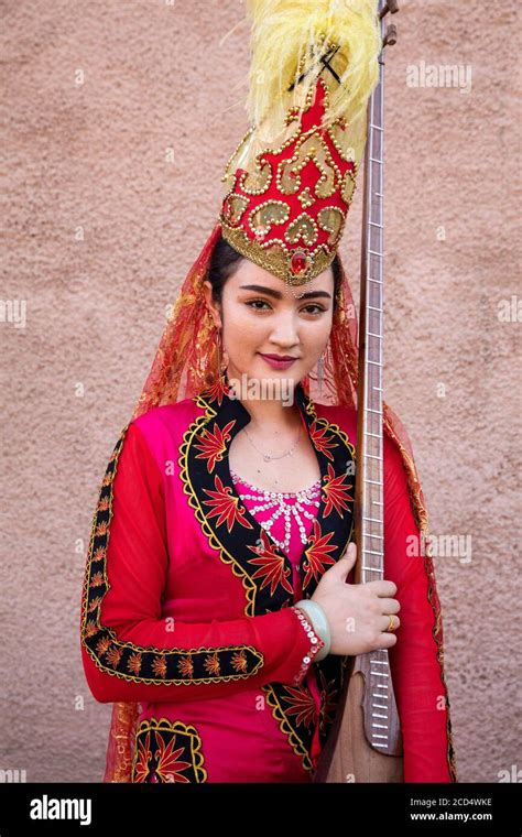 Uyghur Girl In Red Traditional Dress Holding Satar Chinese Long Necked